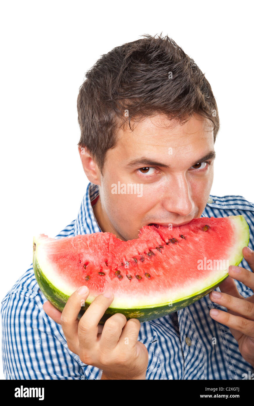 Portrait of young man biting a slice of water melon isolated on white ...
