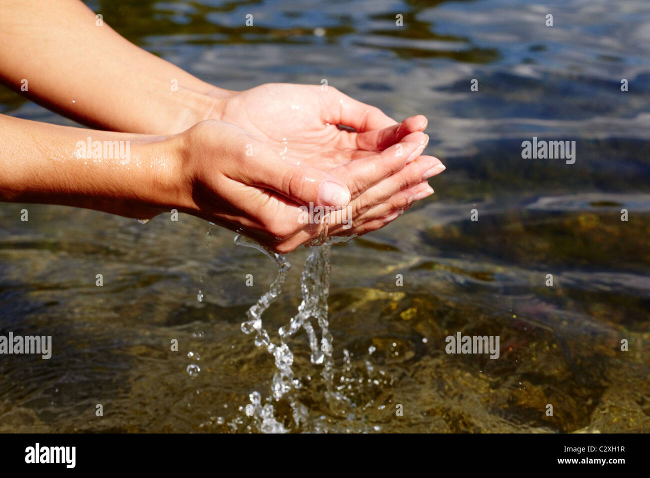 Human hands splashing pure water from river Stock Photo - Alamy