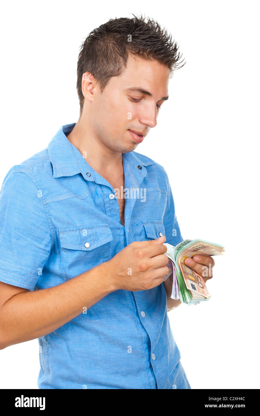 Rich man counts his money and standing in semi profile and smiling ...