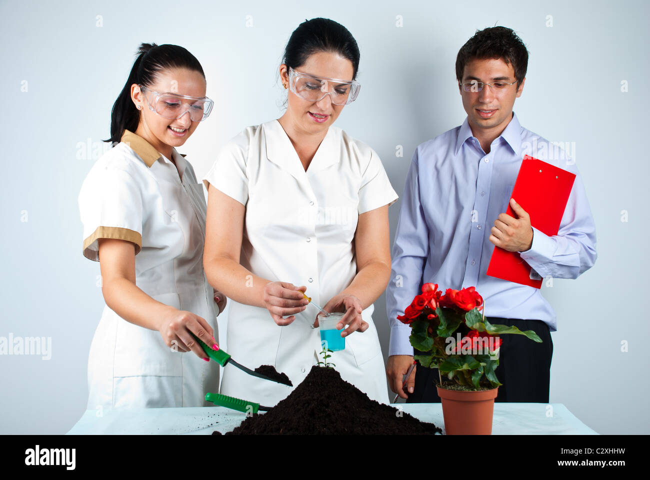 Three happy biologists people making experiments in laboratory Stock ...