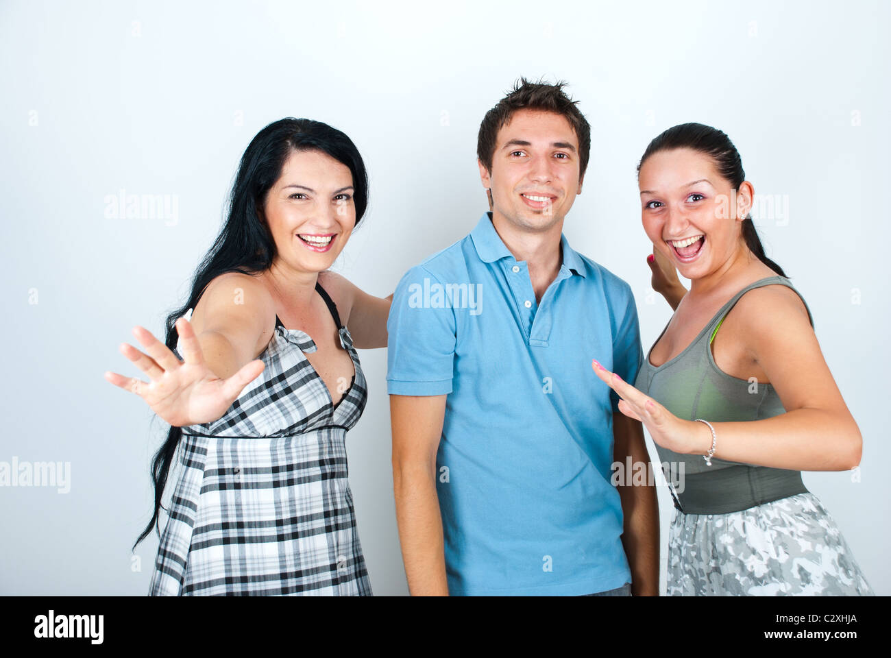 Three young happy friends standing in a row and laughing together Stock ...