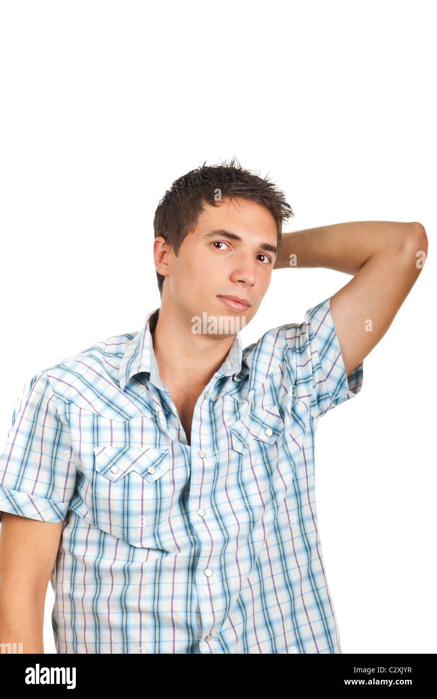 Young casual man in shirt posing with hand under head isolated on white ...