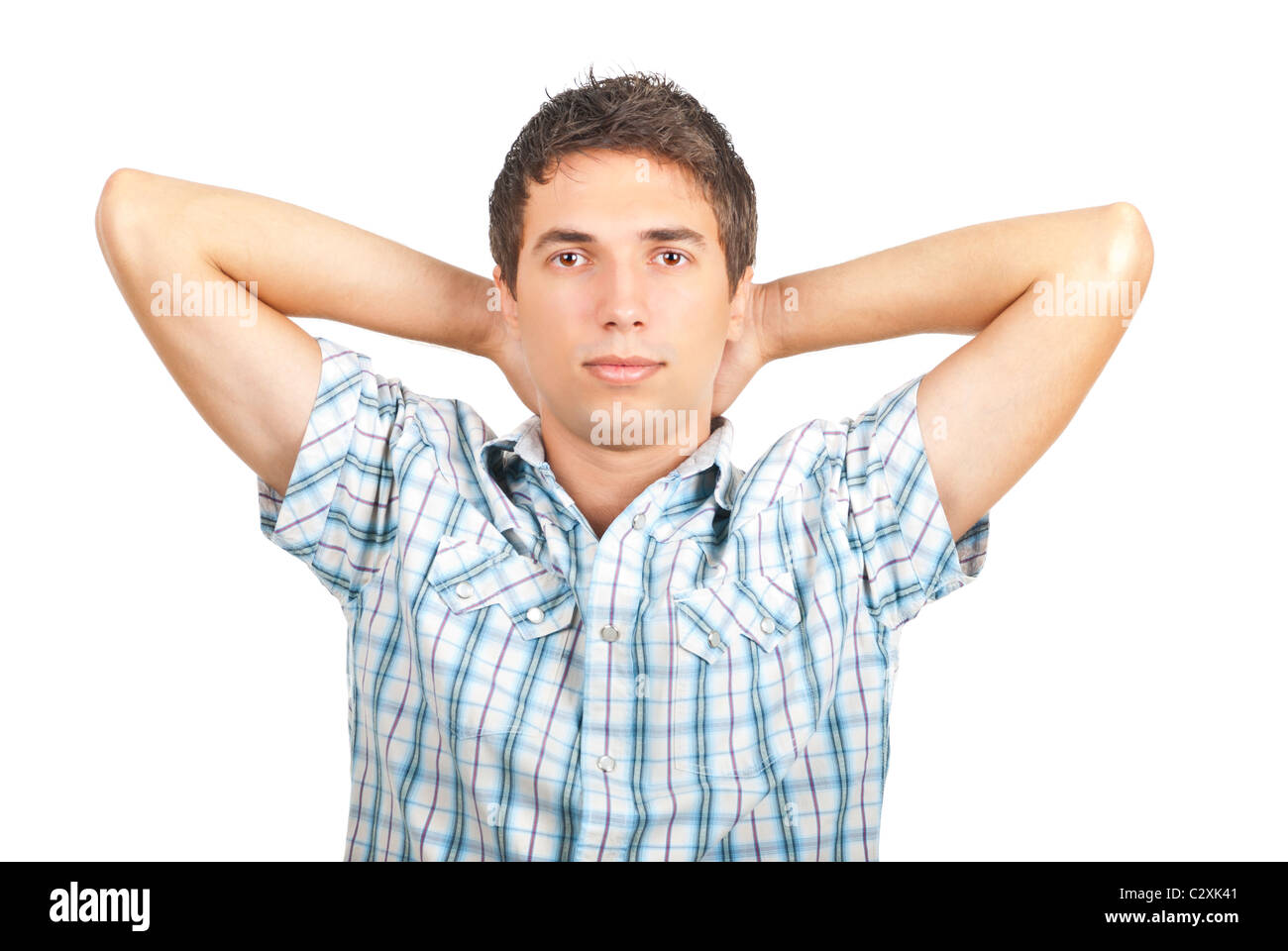 Portrait of young man relaxing with hands under head isolated on white ...