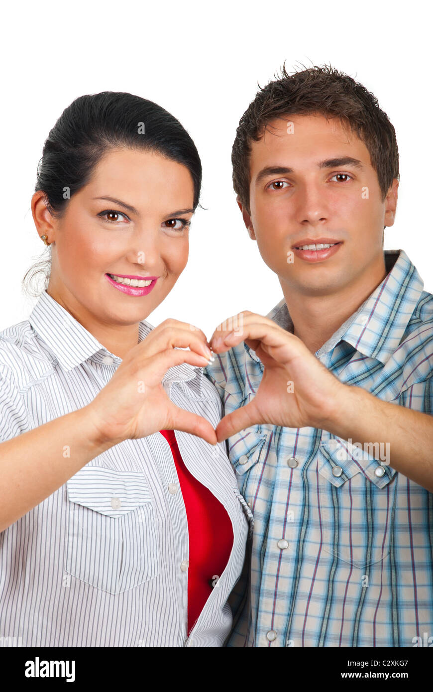 Young couple portrait forming heart shape with their hands isolated on ...