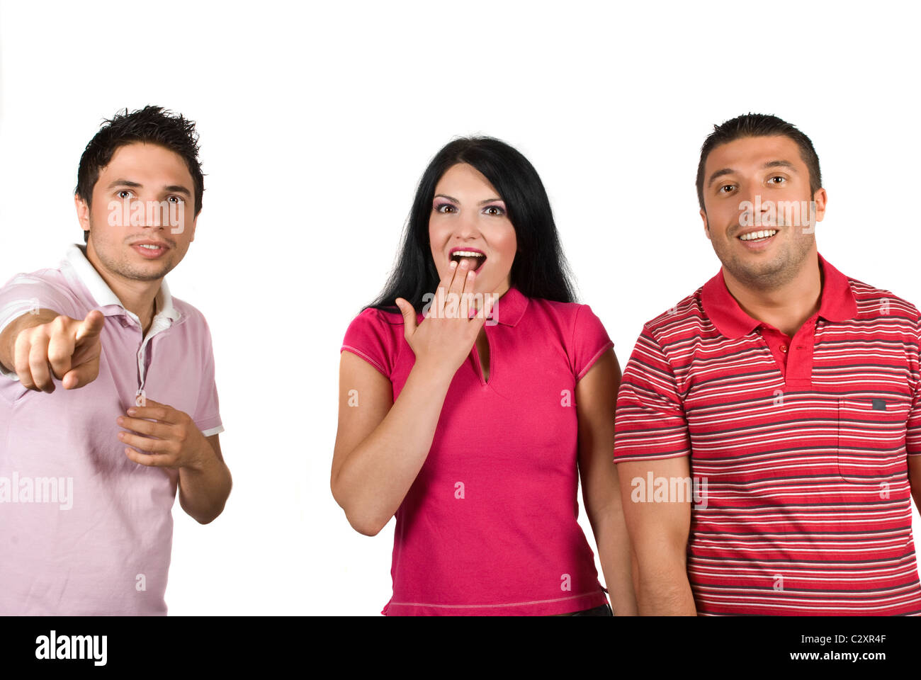 Group of three young people standing in a row and looking very ...