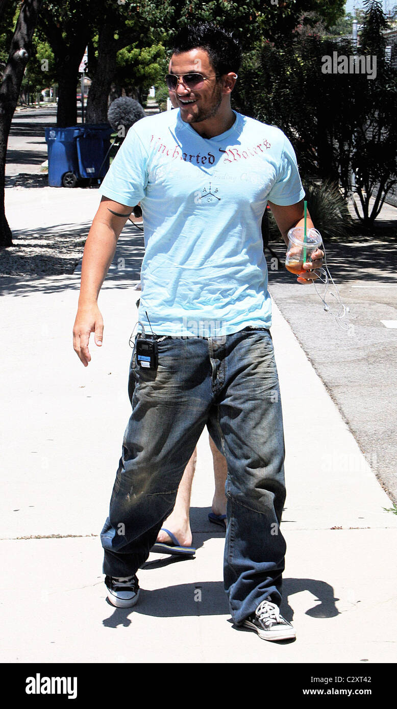 Peter Andre arriving at a recording studio carrying a Starbucks ...