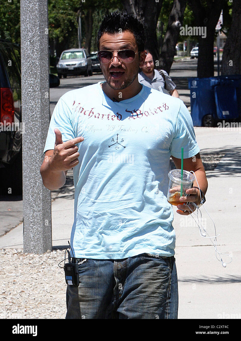 Peter Andre arriving at a recording studio carrying a Starbucks ...