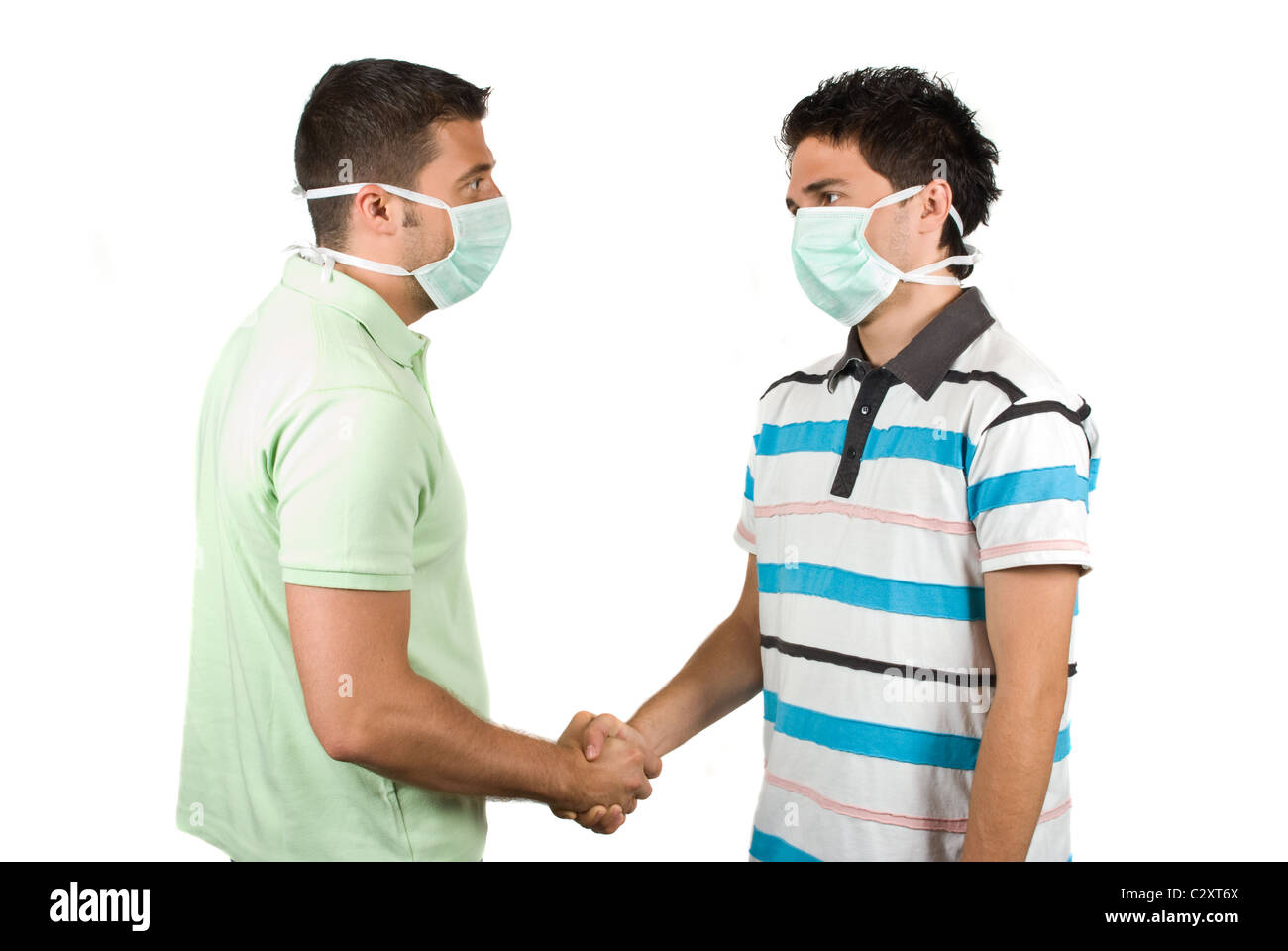 Portrait of two young people colleagues giving handshake and wearing ...