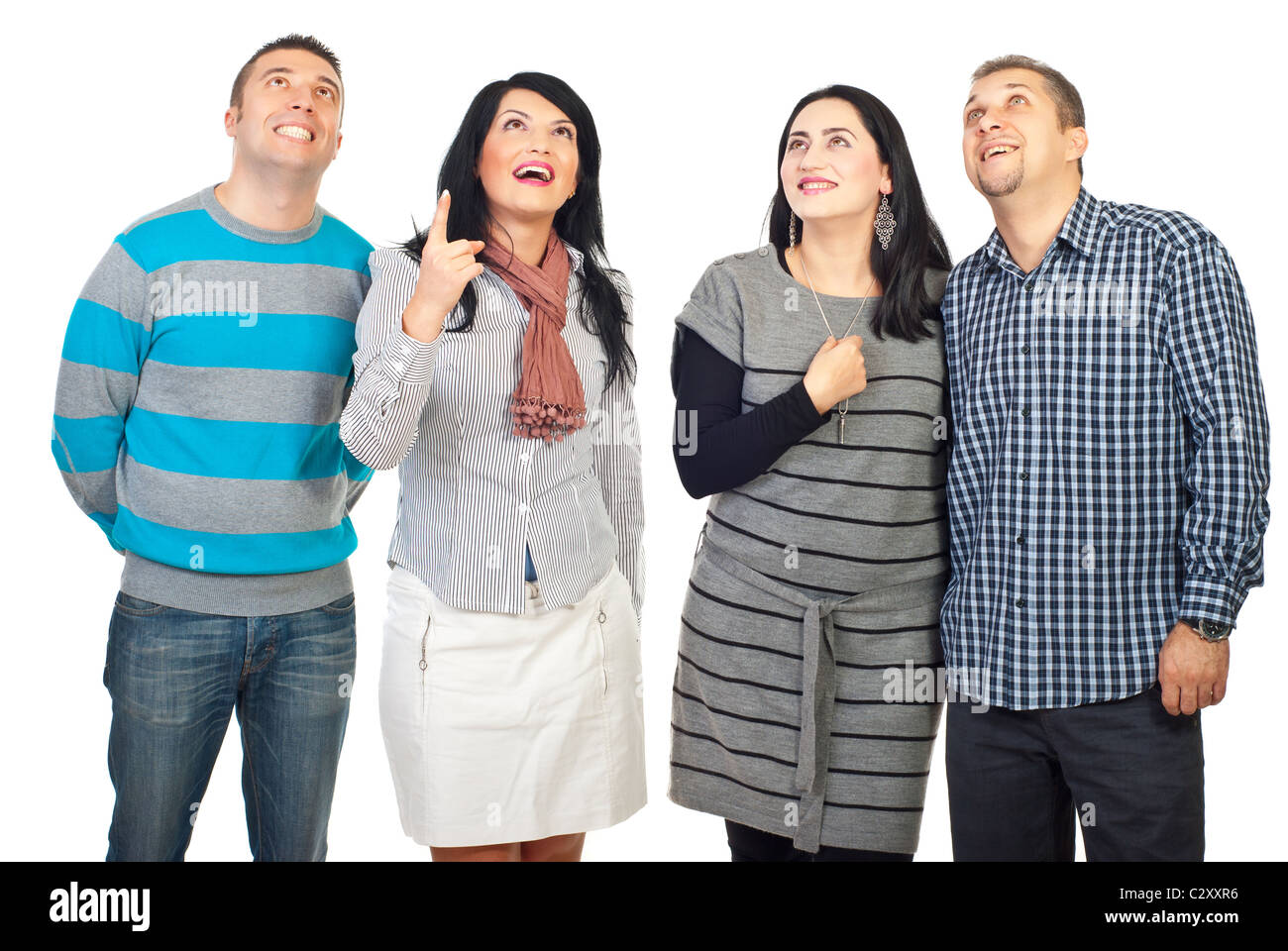 Woman pointing up and all group of friends looking up with happy ...