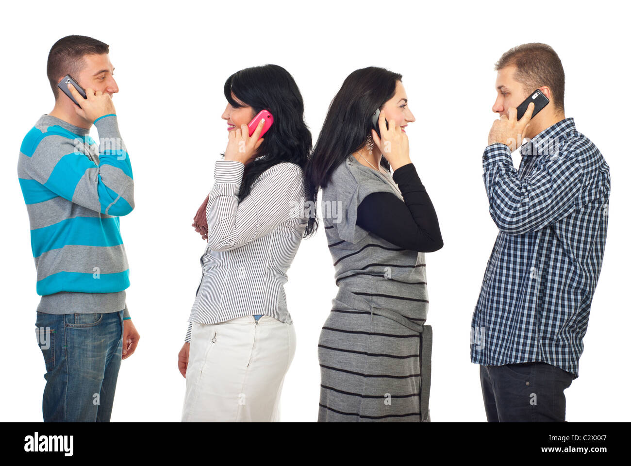 Two couples talking by phone mobiles and each of them standing in ...