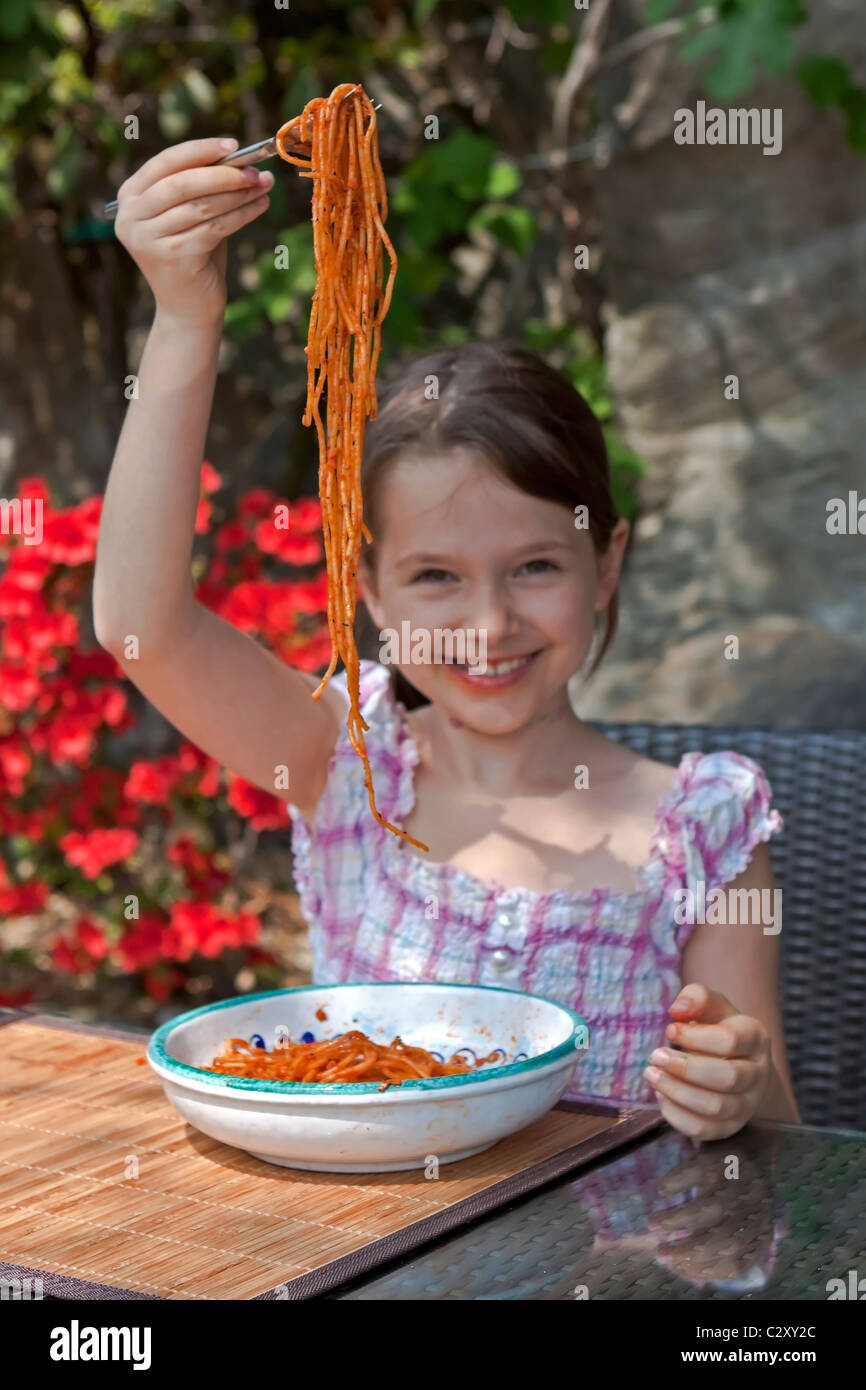 girl is eating spaghetti Stock Photo - Alamy