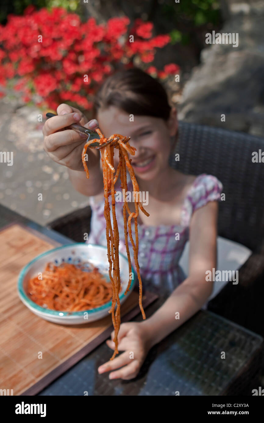 girl is eating spaghetti Stock Photo - Alamy