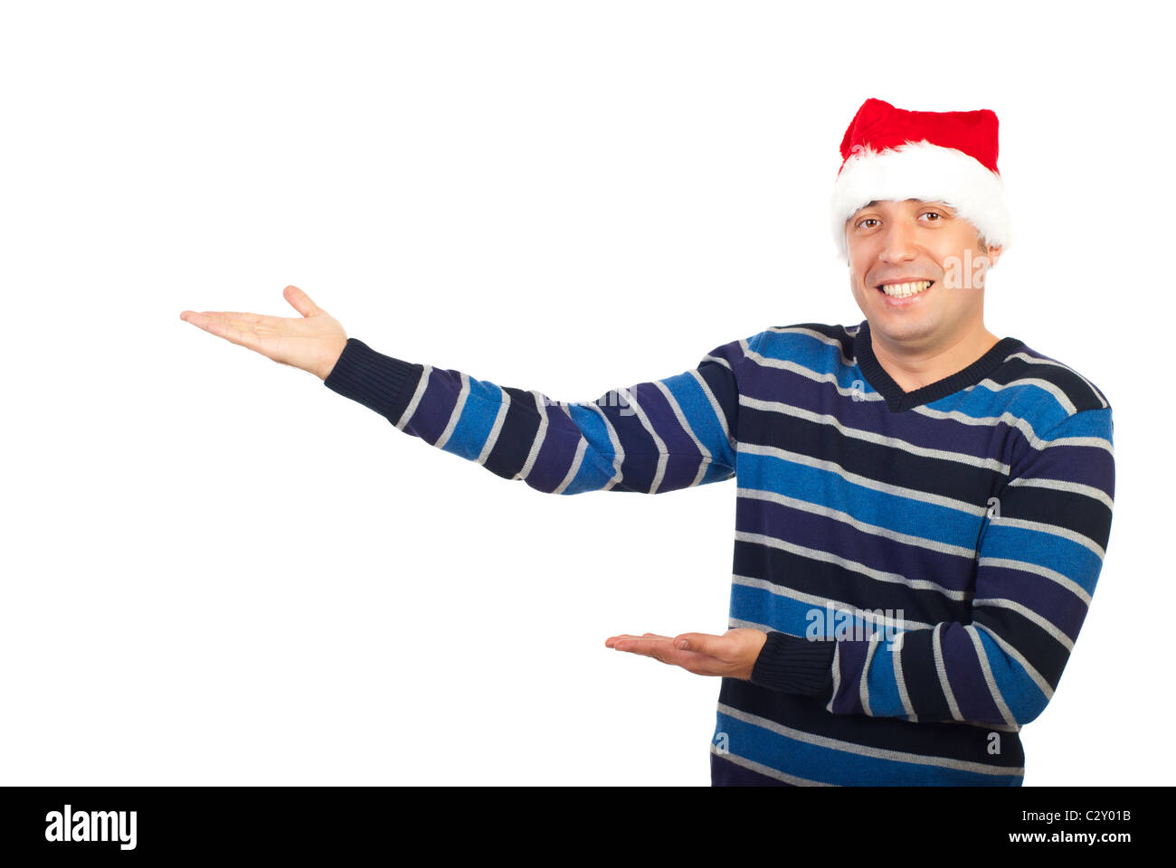 Smiling man with Santa hat making presentation to left part of image ...