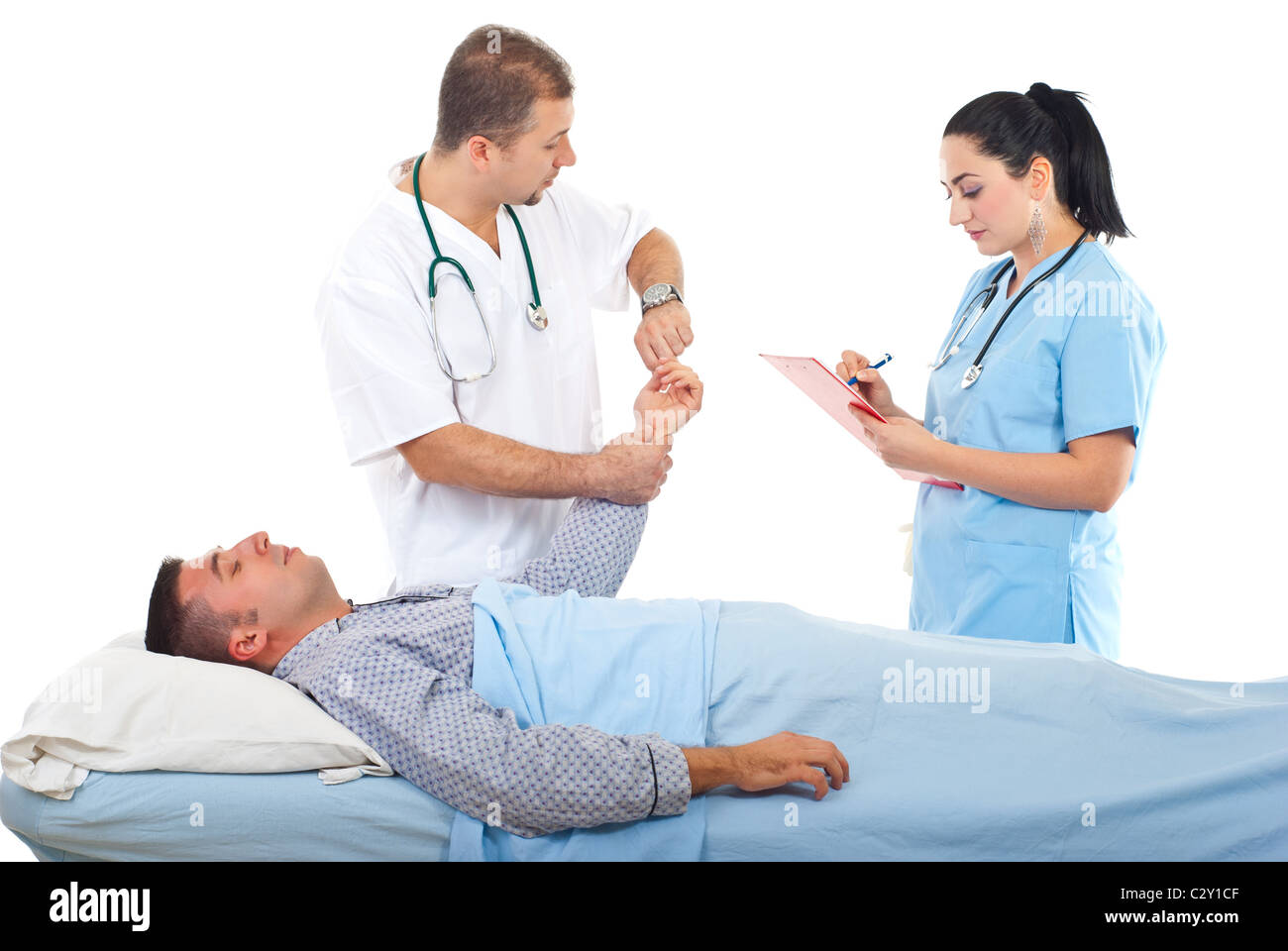 Doctor taking patient sleeping man pulse while a nurse writing in ...