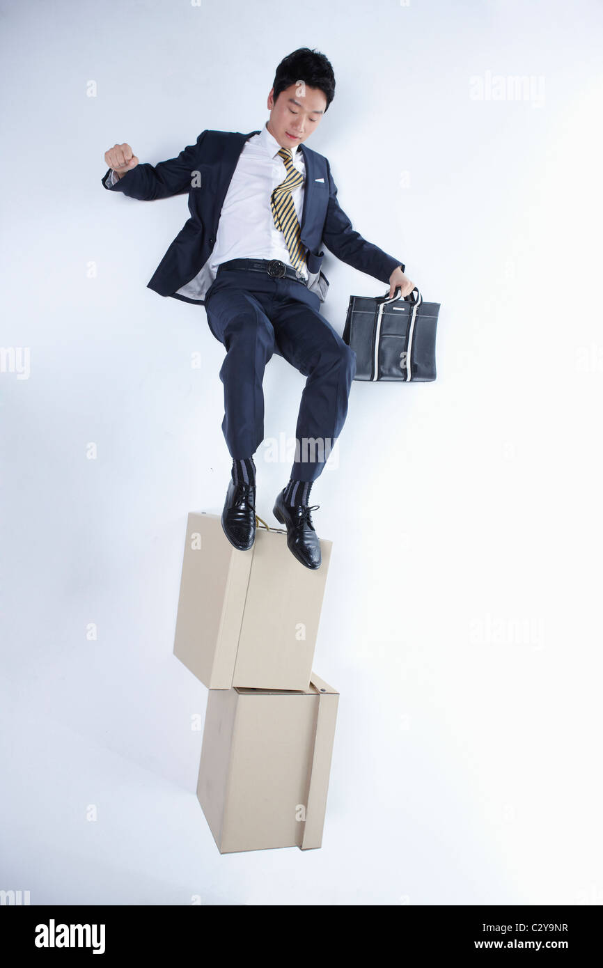busy business man on the boxes Stock Photo - Alamy