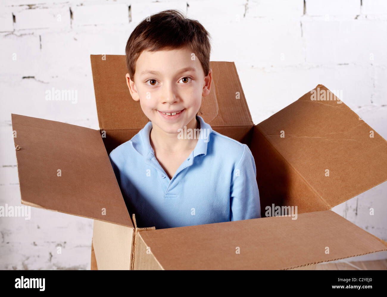 Portrait of happy kid in box looking at camera Stock Photo - Alamy