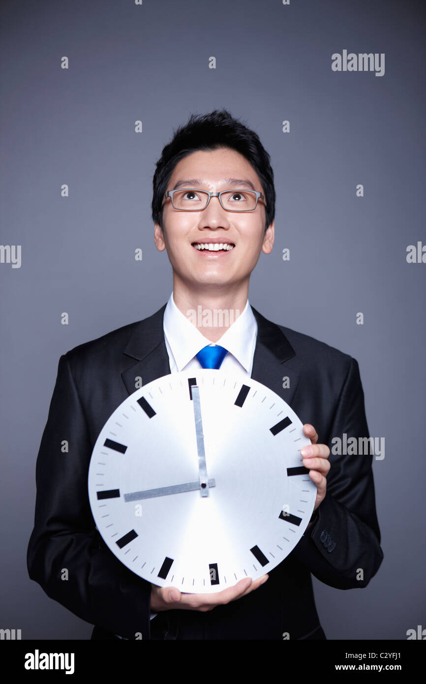 businessman holding clock Stock Photo - Alamy