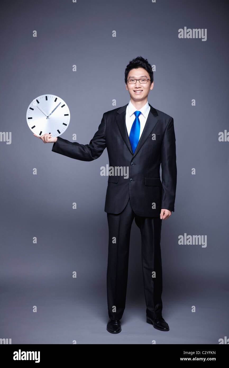businessman holding clock Stock Photo - Alamy