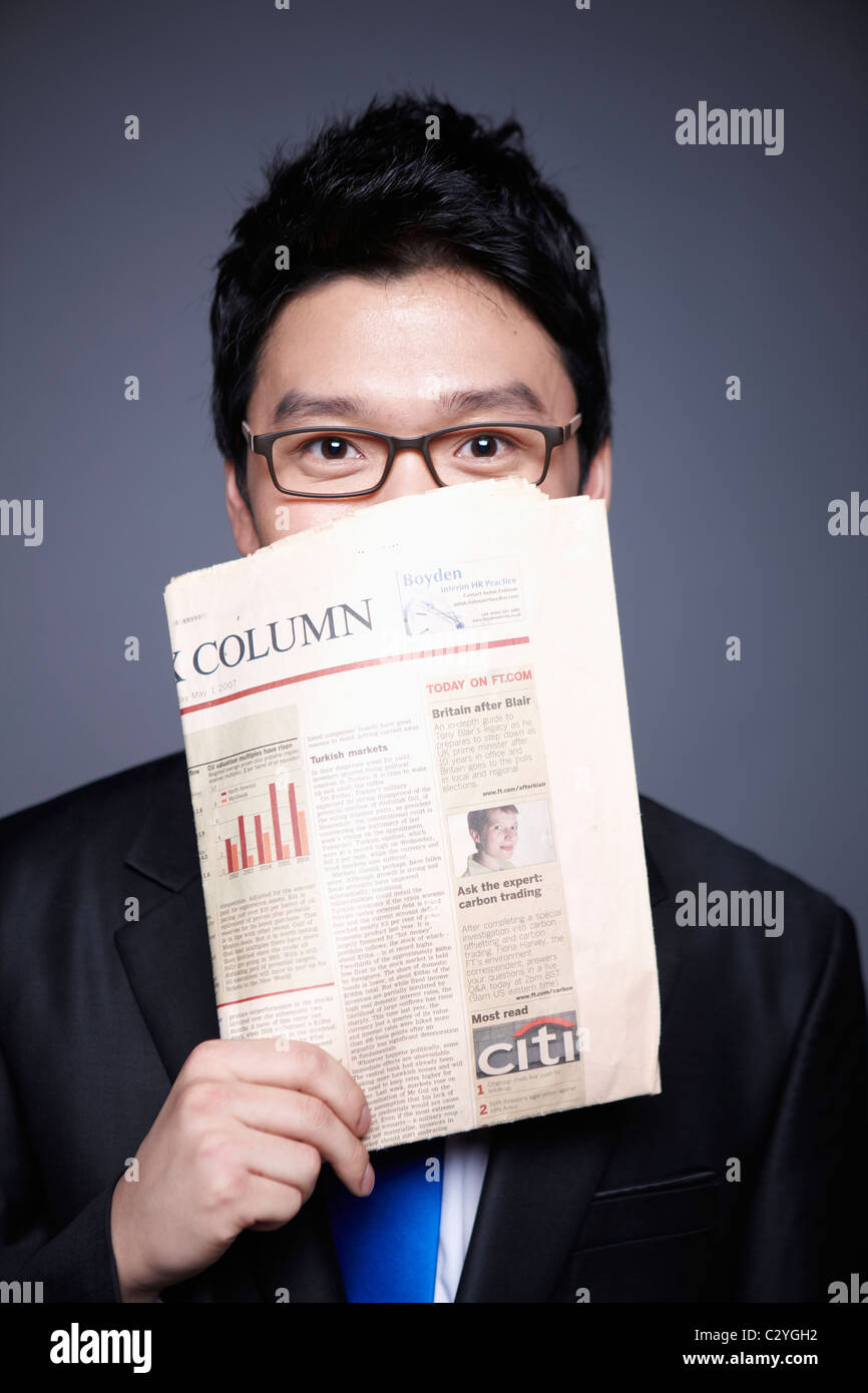 Hiding behind newspaper hi-res stock photography and images - Alamy