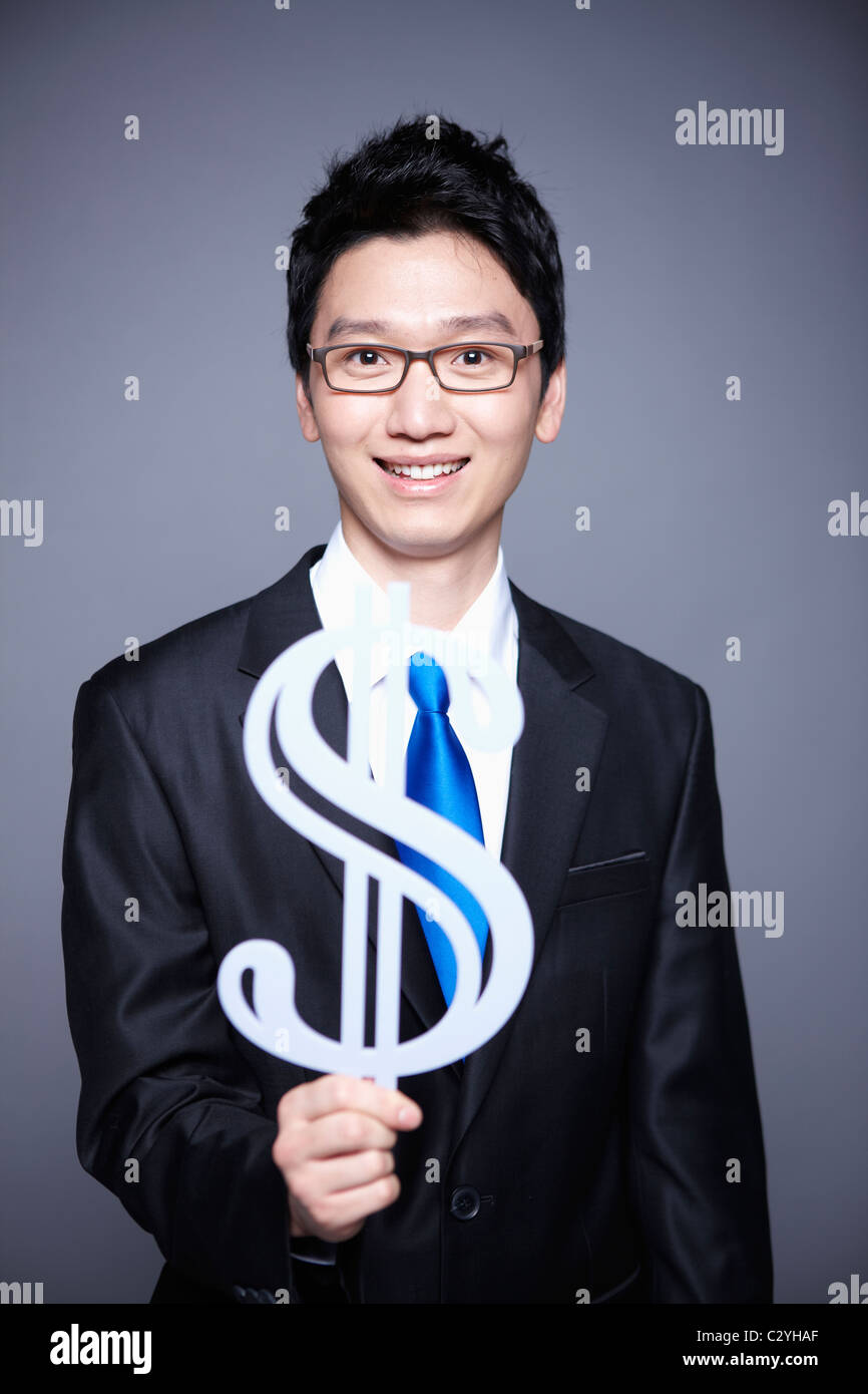 businessman holding dollar sign Stock Photo - Alamy