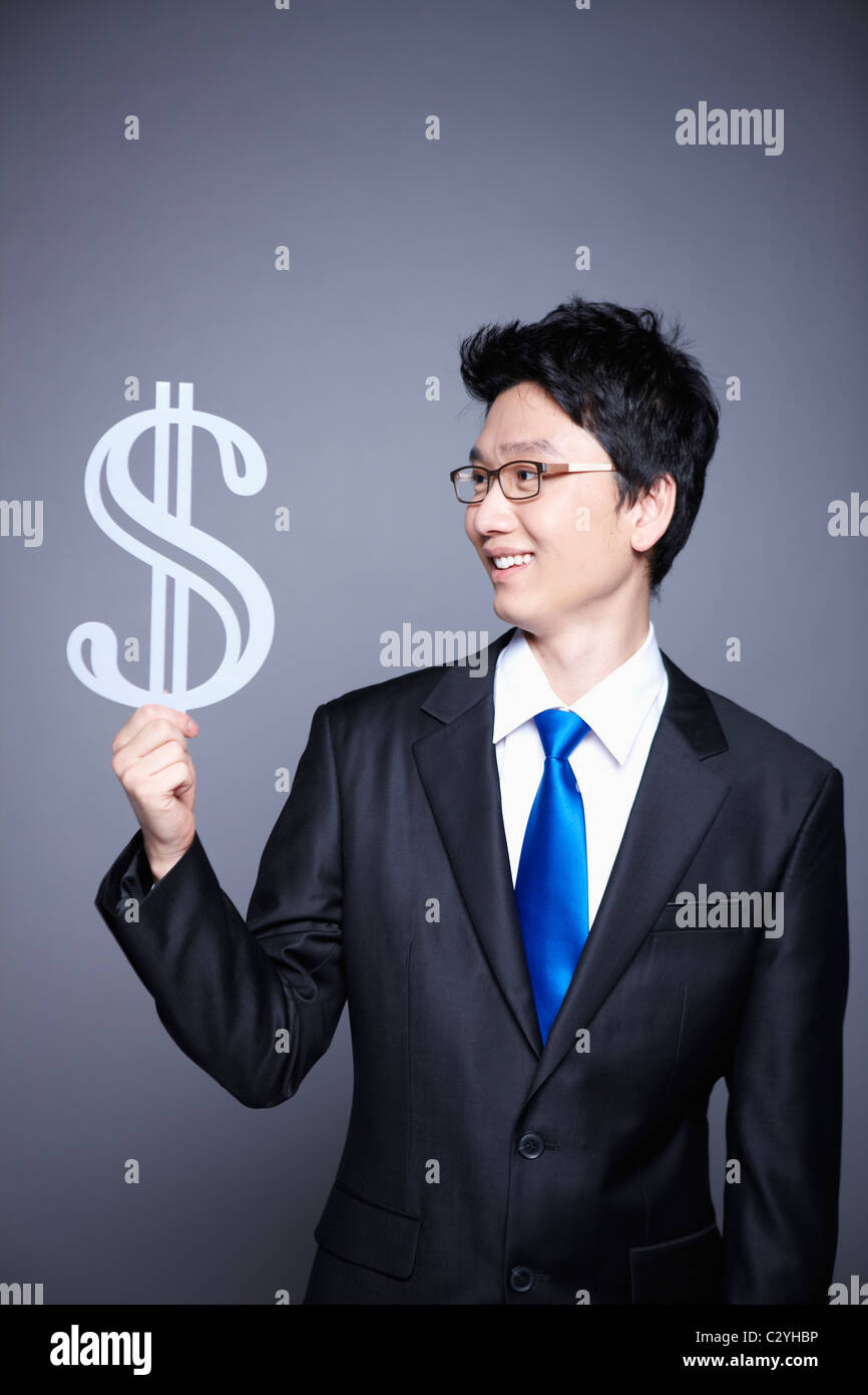businessman holding dollar sign Stock Photo - Alamy