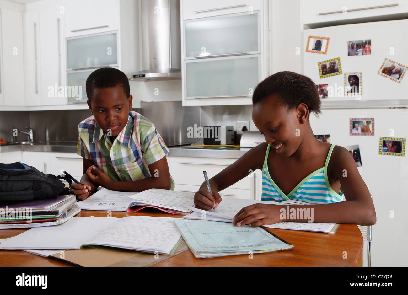 Siblings doing homework together, Johannesburg, South Africa Stock ...