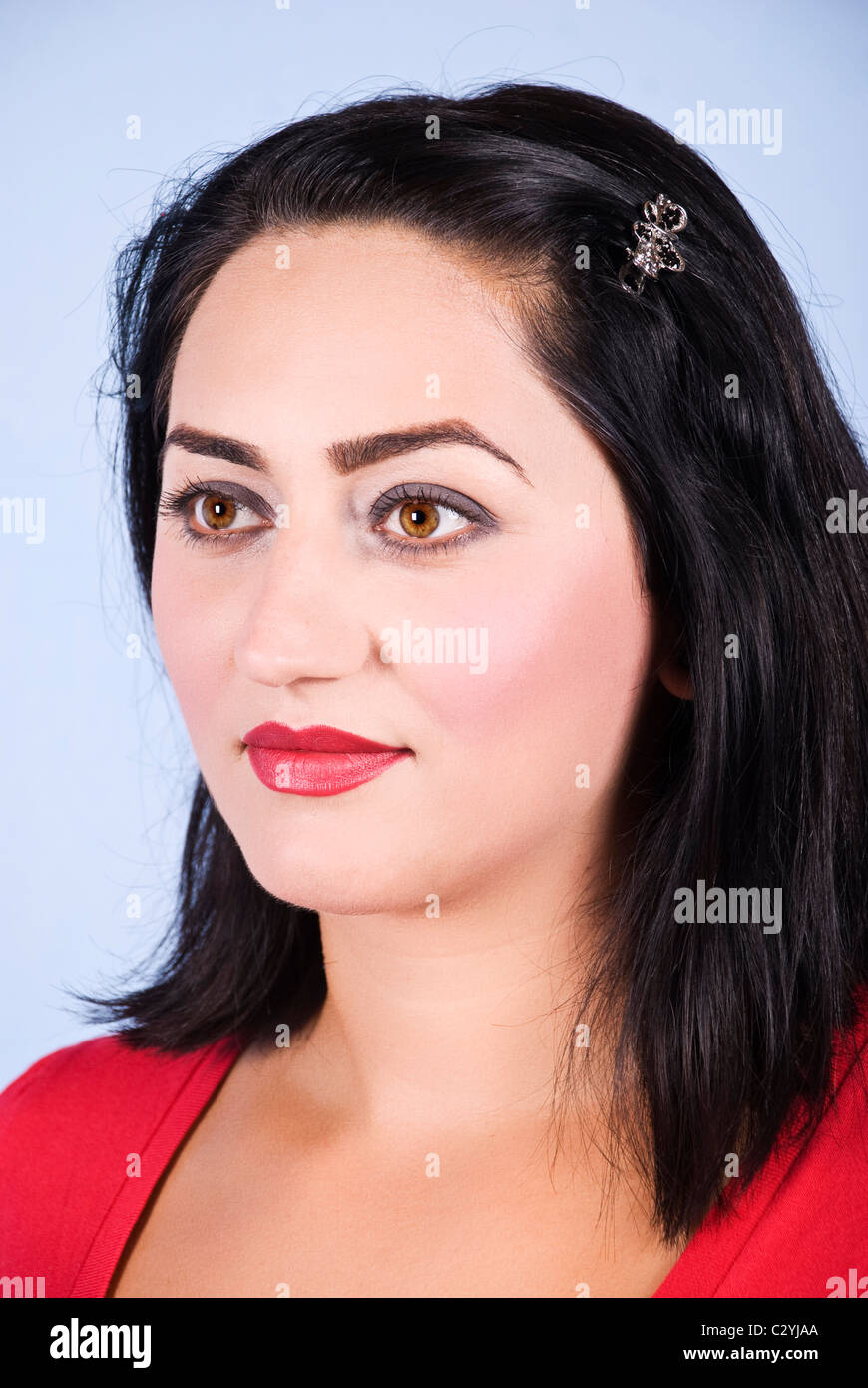 Portrait of beautiful mid adult woman with green big eyes looking away ...