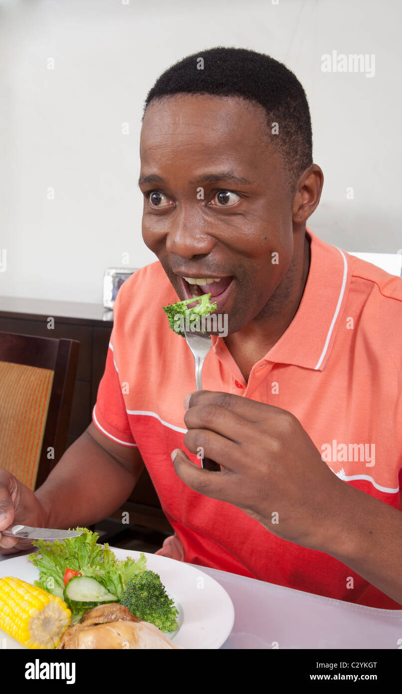 Man eating at dining room table, Johannesburg, South Africa Stock Photo ...