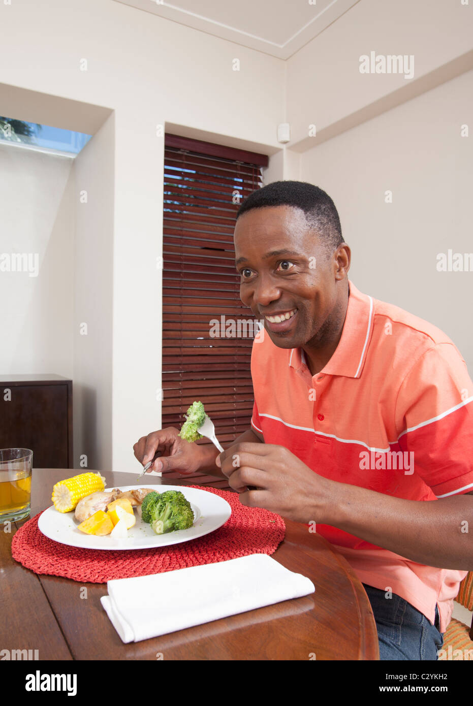 Man eating at dining room table, Johannesburg, South Africa Stock Photo ...