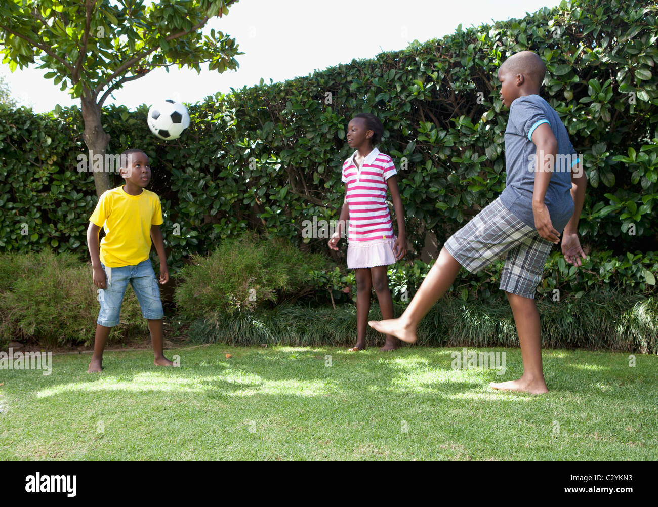 Children playing soccer in garden, Johannesburg, South Africa Stock ...