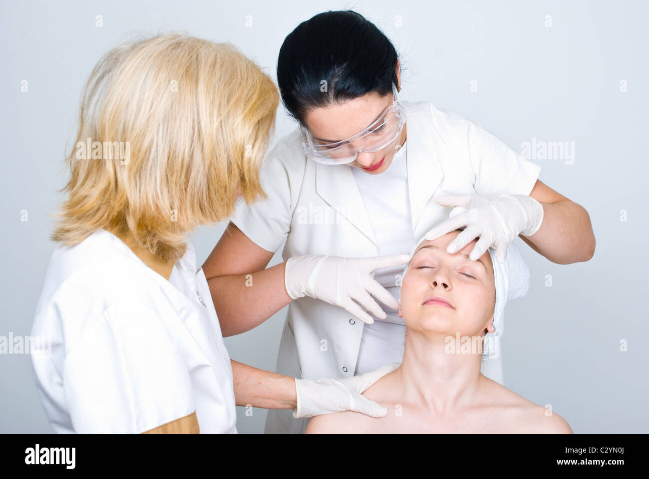 Two doctors women consulting a patient woman skin and the young doctor ...
