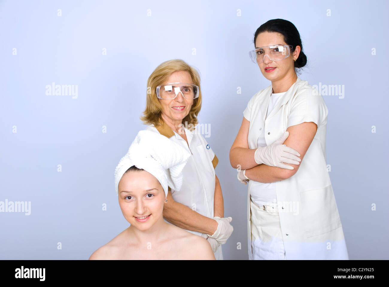 Young woman patient in front of image with two women plastic surgeon ...