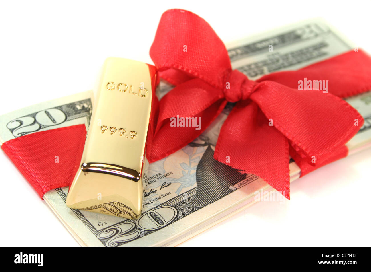 three large gold bars on a bundle of dollar bills Stock Photo - Alamy