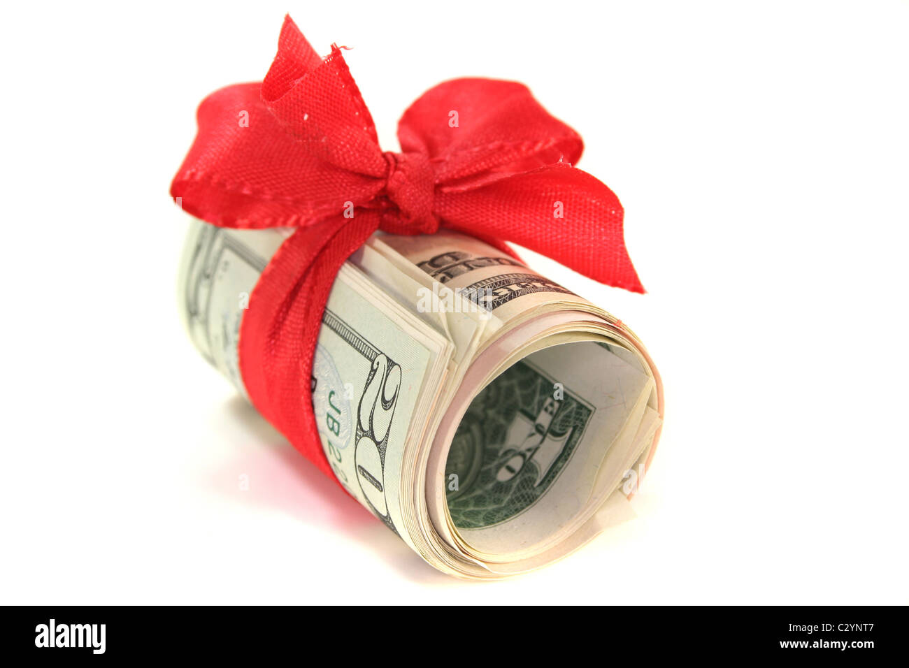 many dollar bills with a red ribbon on white background Stock Photo - Alamy