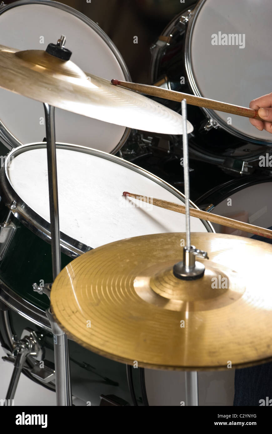 Human hand holding drumsticks playing drums and cymbal Stock Photo - Alamy