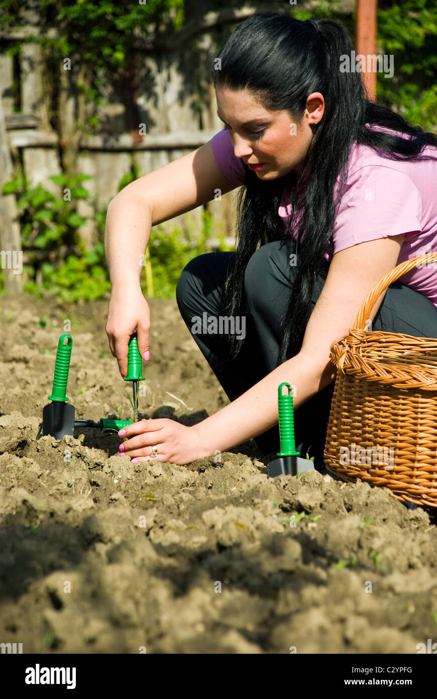 Young woman working in garden and using tools at countryside Stock ...