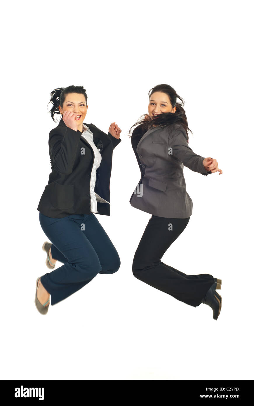 Two cheerful business women jumping and cheering isolated on white ...
