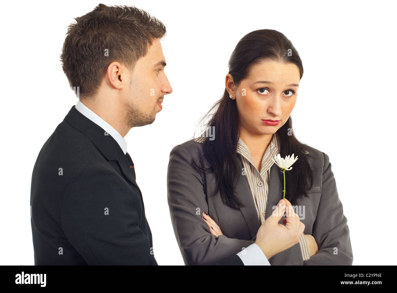 Business man offering a little flower to his sad colleague woman with ...