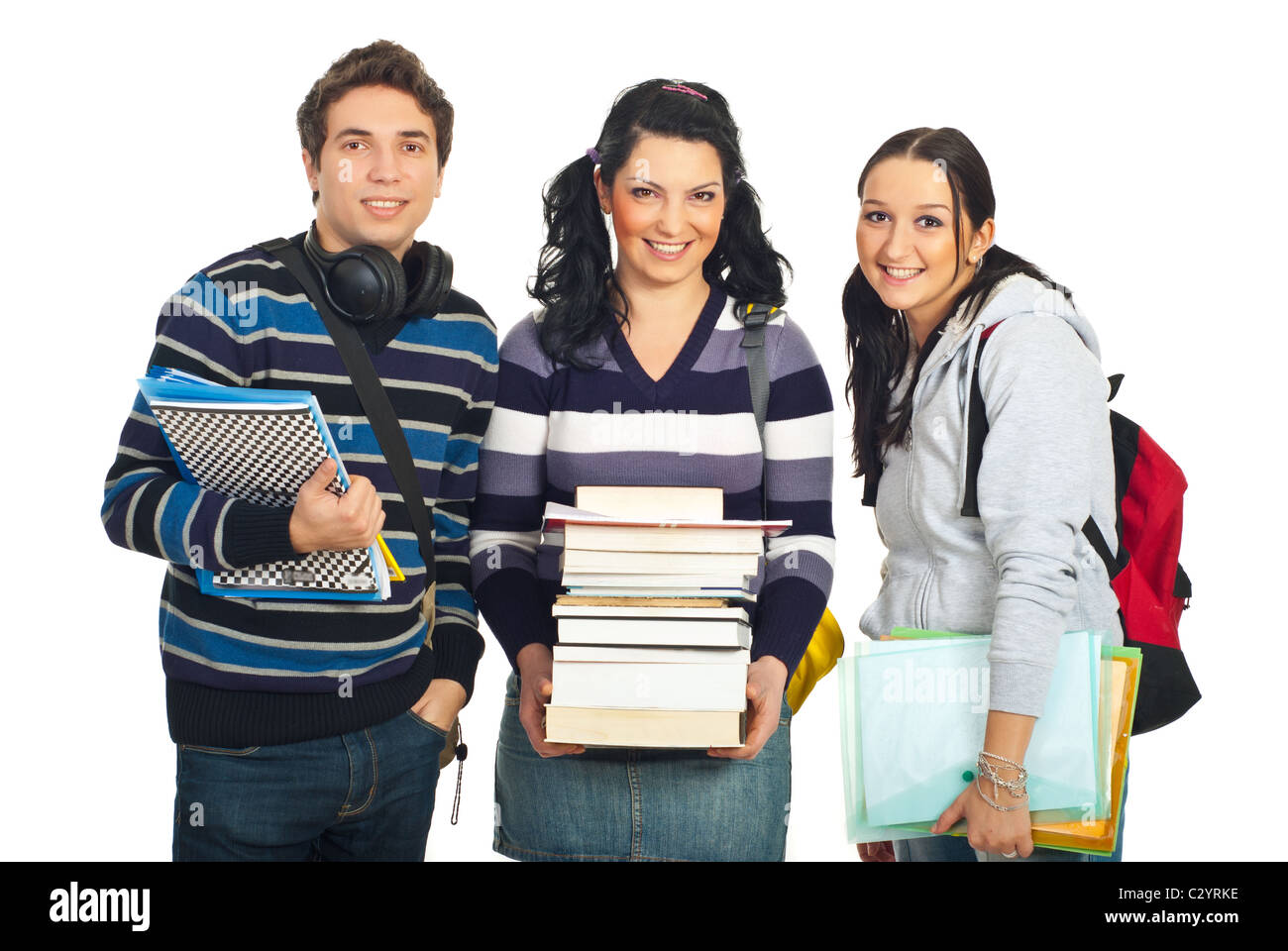 Happy team of three students with books and notebooks standing in a row ...