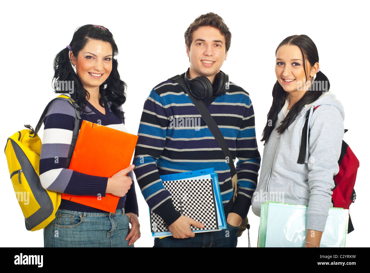 Cheerful three students standing in a row and smiling isolated on white ...