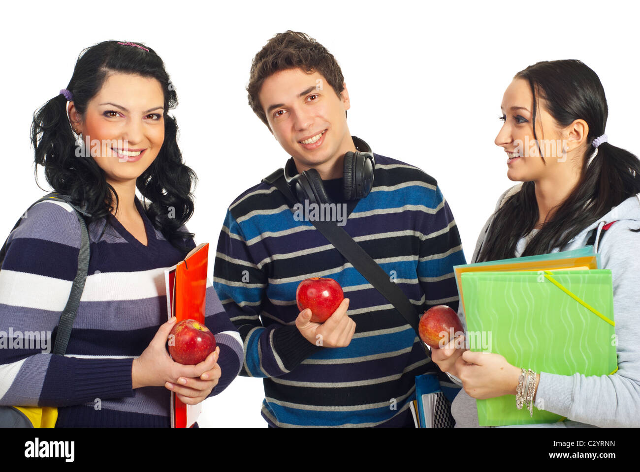 Healthy team of three students holding apples and notebooks isolated on ...
