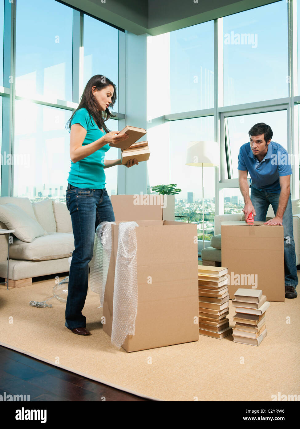 Mixed race couple unpacking boxes hi-res stock photography and images ...
