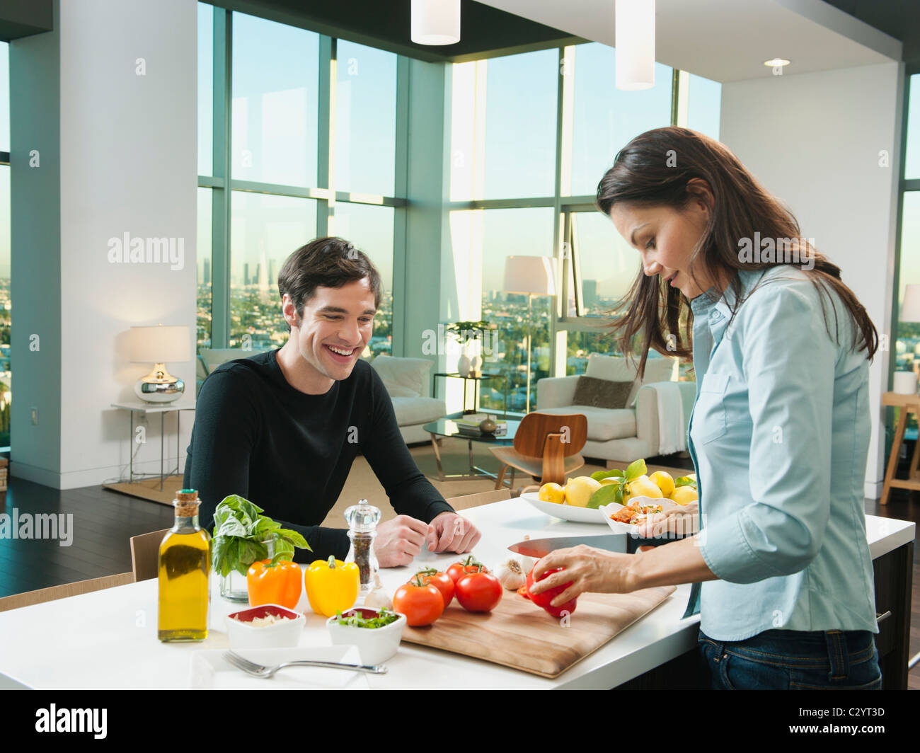 Couple making dinner together in kitchen Stock Photo - Alamy