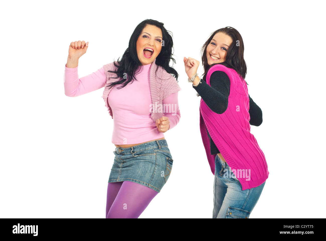Two young women in pink clothes dancing and having fun isolated on ...