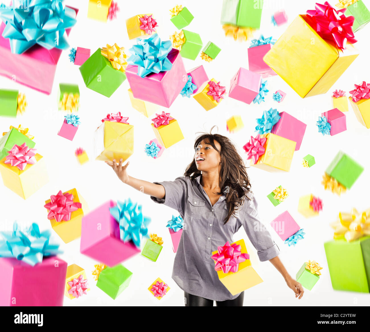 African American woman with falling birthday presents Stock Photo - Alamy