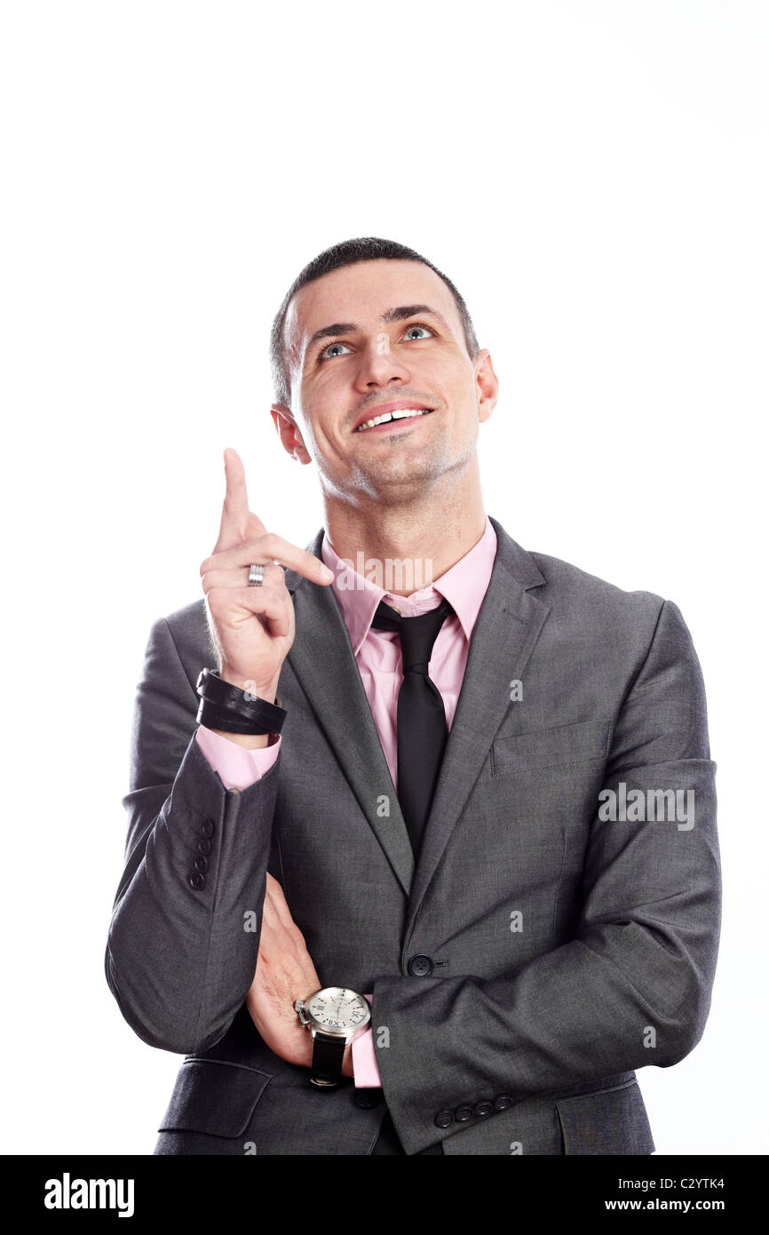 Businessman pointing up at copyspace isolated on white background Stock ...