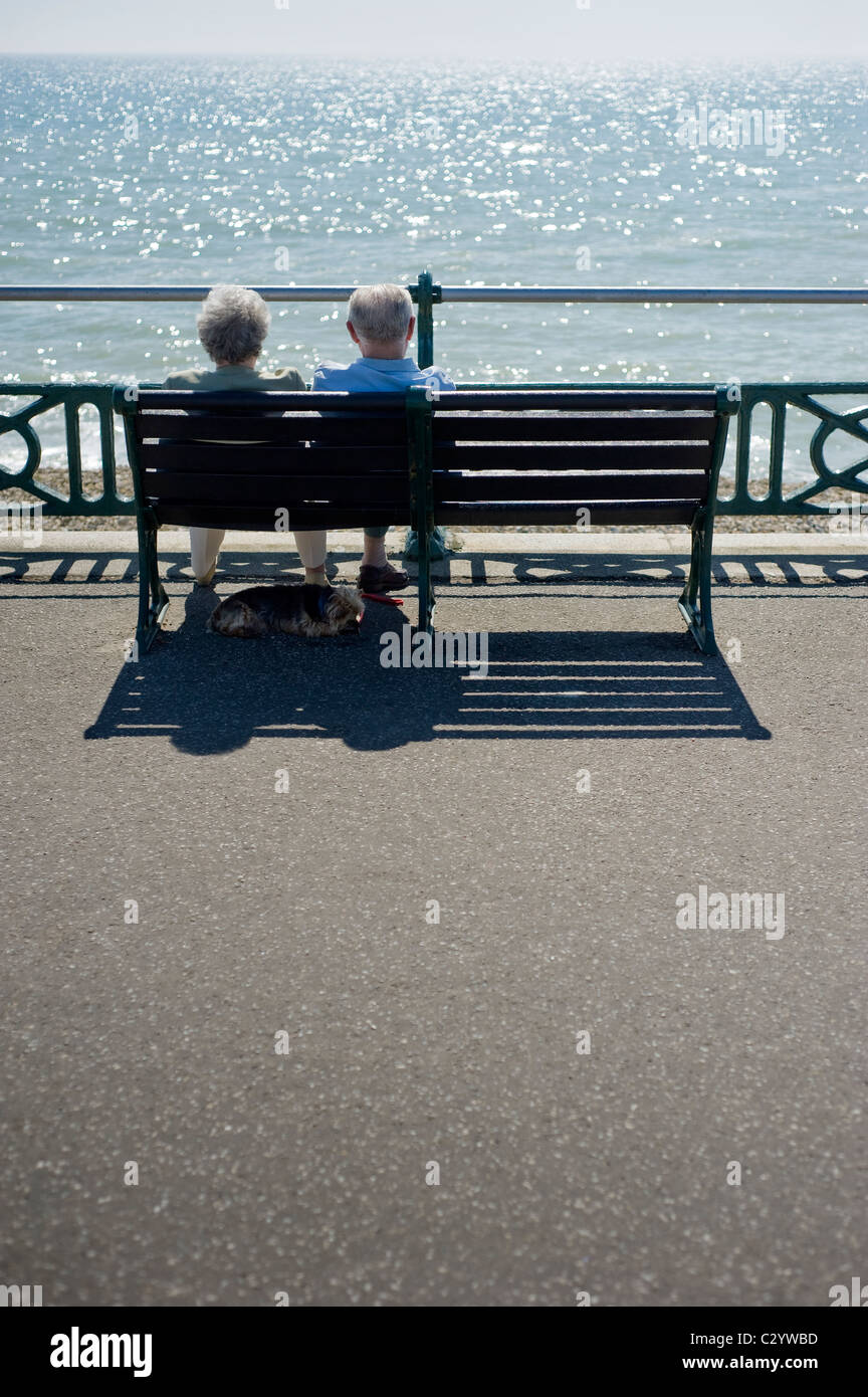 Retirement concept. Elderly Couple on a Promenade Bench Enjoying the ...