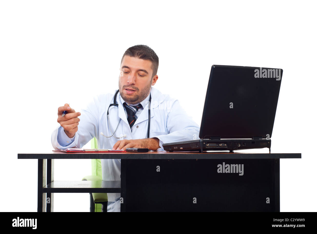 Busy doctor man writing at desktop in his office isolated on white ...