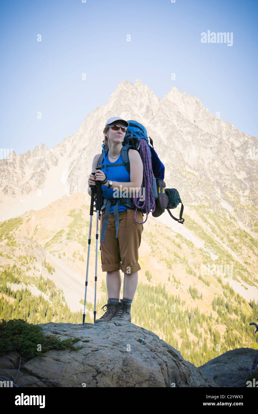 Woman with heavy backpack on posing before Mount Stuart in the Central ...