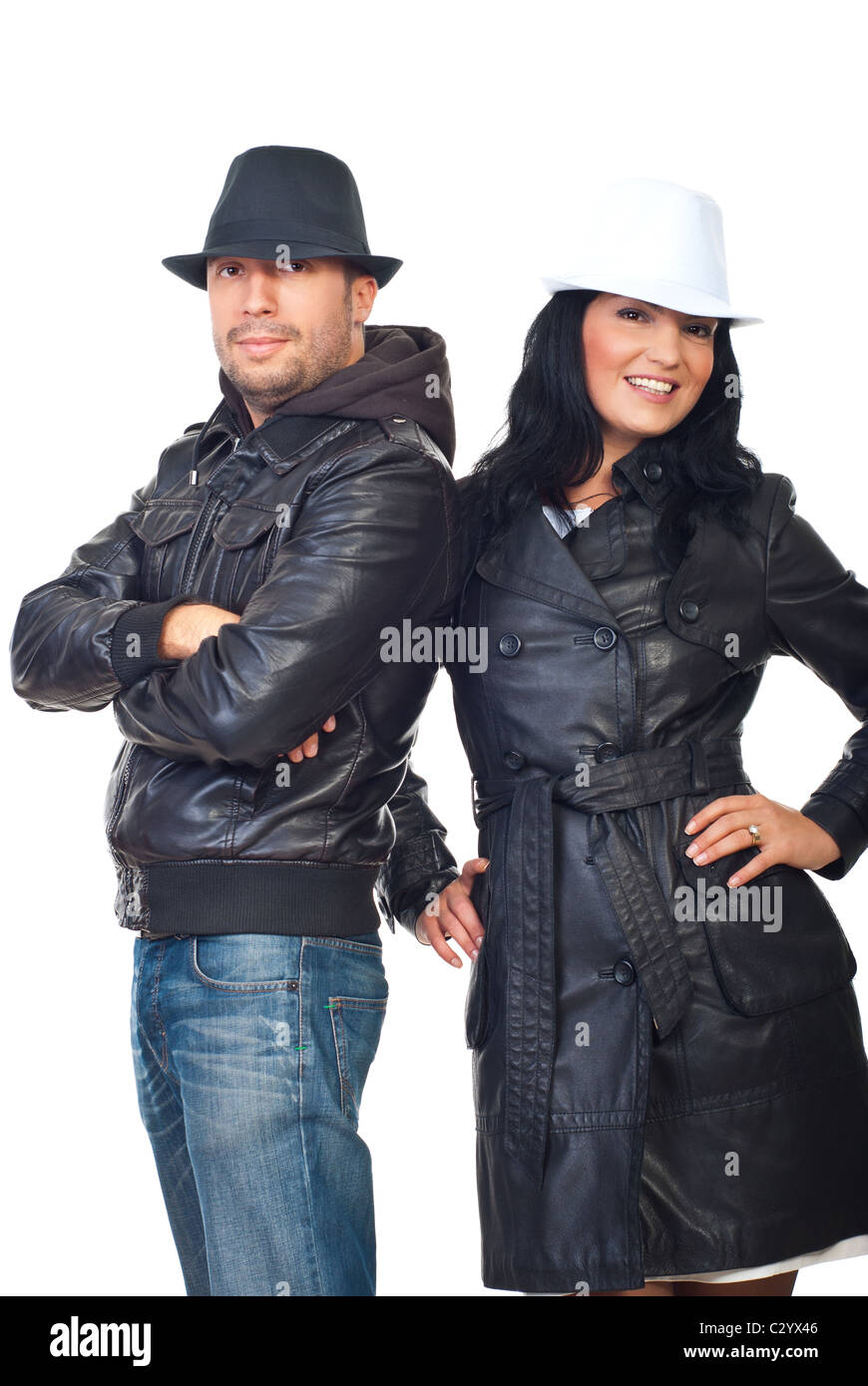 Fashionable couple wearing leather jackets and hats isolated on white ...